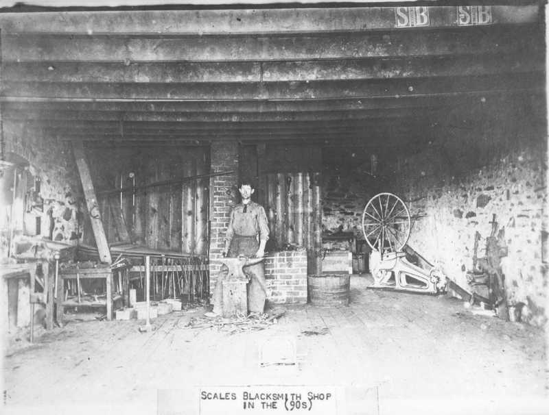 Scales Blacksmith Shop with a Blacksmith Posing at His Forge ca. 1890s