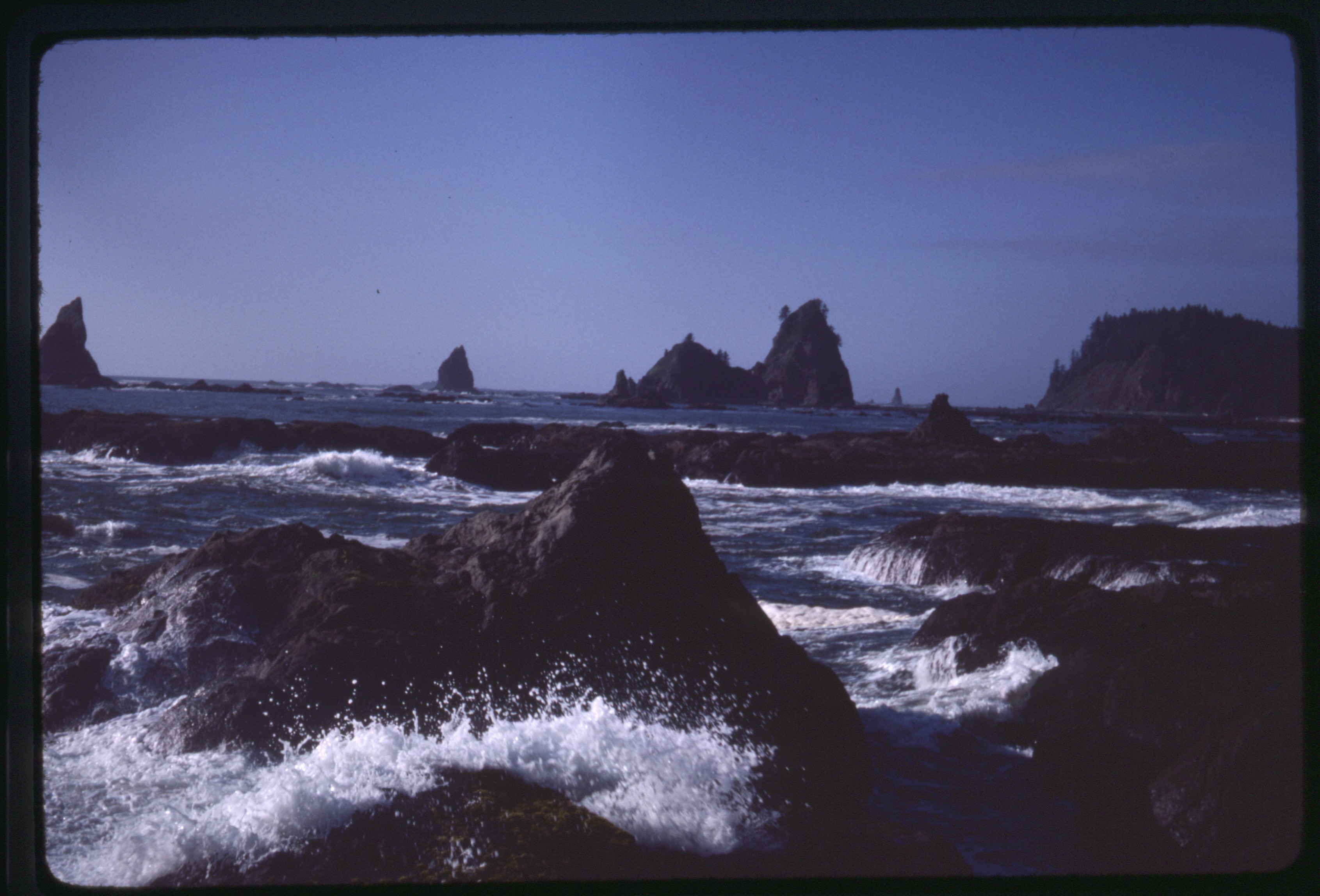 Tide breaking across the rocky neck between trough and ocean