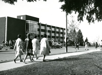 Women Walking in Front of Reid Hall on Montana State College's Campus