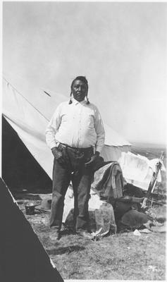 Black and white photo of Big Sorrel Horse standing in front of a tent