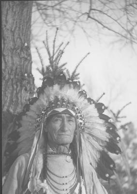 Photo of Eli Guardipee wearing a head dress