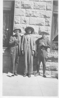 Photo of Eli Guardipee and friends standing in front of a stone wall.